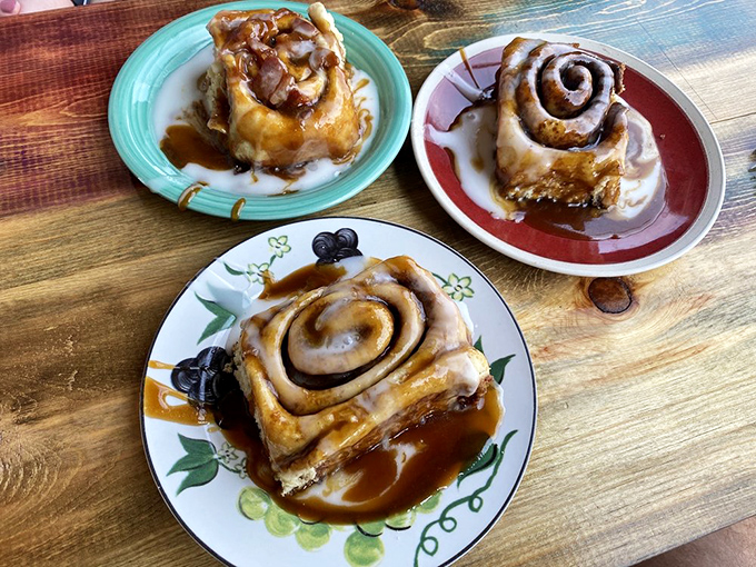 Three distinct personalities on display: classic cinnamon, caramel-drenched decadence, and what appears to be a berry-infused creation. The breakfast version of "Choose Your Own Adventure."