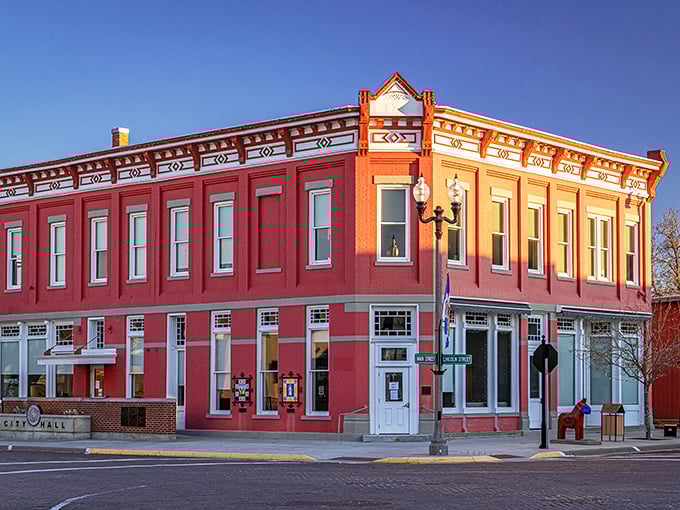 City Hall stands proudly on the corner, its brick fa&ccedil;ade catching the golden hour light like it's posing for a small-town calendar.