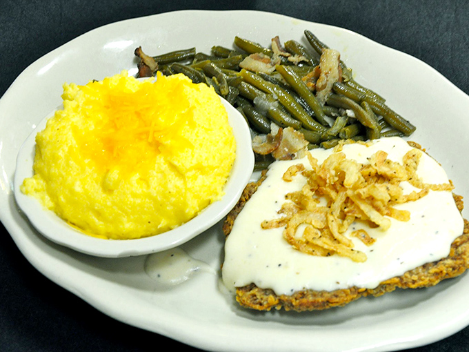 Country fried steak with creamy gravy alongside sunshine-yellow cheese grits and green beans&mdash;comfort food that would make your grandmother envious.