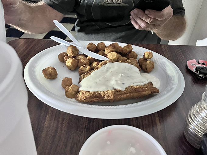 Country fried steak smothered in white gravy alongside tater tots&mdash;proof that some culinary equations simply cannot be improved upon.