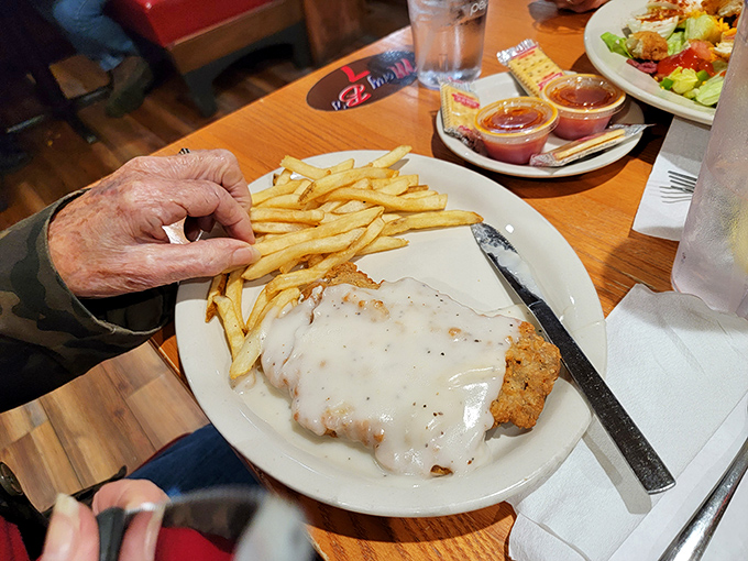 Country fried steak with cream gravy and golden fries&mdash;the kind of plate that makes diet plans spontaneously combust upon arrival at your table.