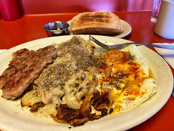 Country sausage and gravy-smothered eggs—proof that sometimes the most beautiful things in life aren't beautiful at all, just delicious.