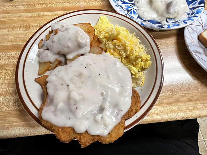 Country fried steak smothered in gravy with scrambled eggs on the side&mdash;the breakfast equivalent of a warm hug from someone who genuinely likes you.