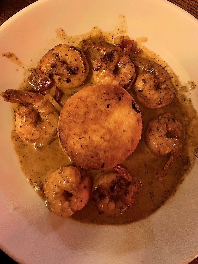 The holy trinity of dining: perfectly seared shrimp, a golden throne of grits, and sauce worth committing minor crimes for.