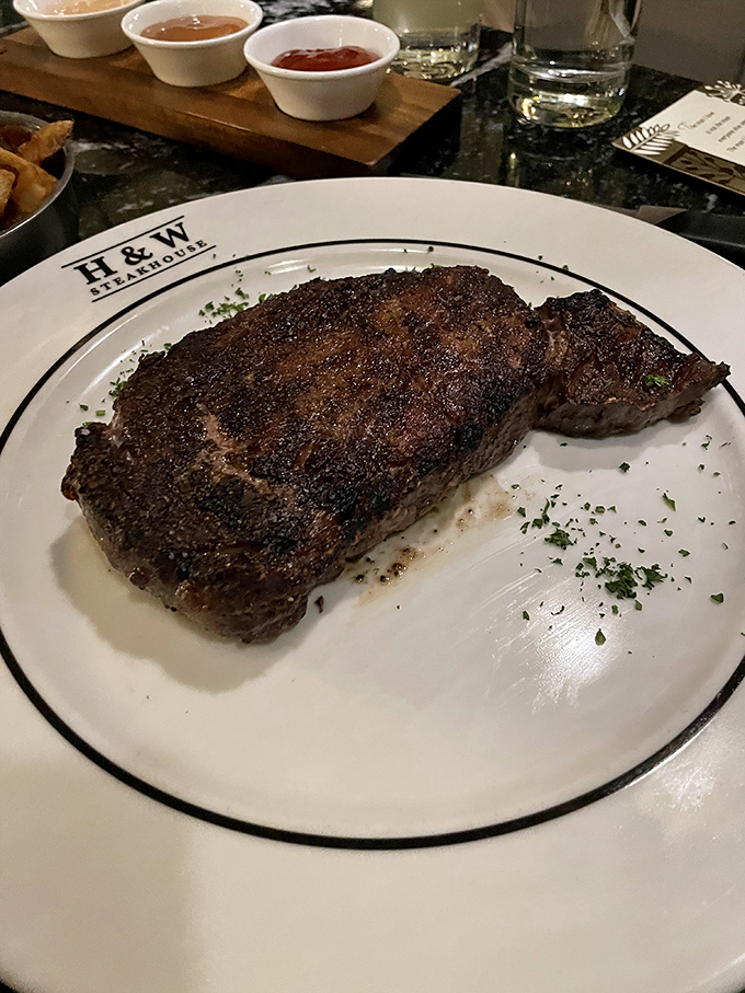 The Delmonico Ribeye arrives with a crust that crackles with promise, revealing a perfectly rosy interior that beef aficionados dream about.