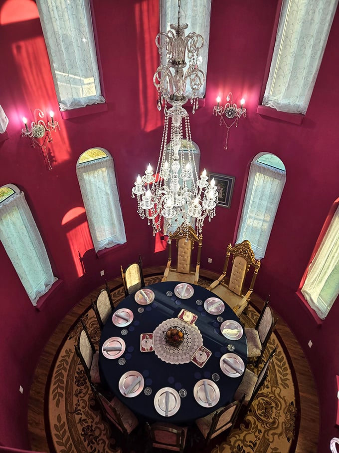 Dining beneath a crystal chandelier in a crimson tower room? Just Tuesday at Uhuburg. King Arthur would approve of this regal round table setup.