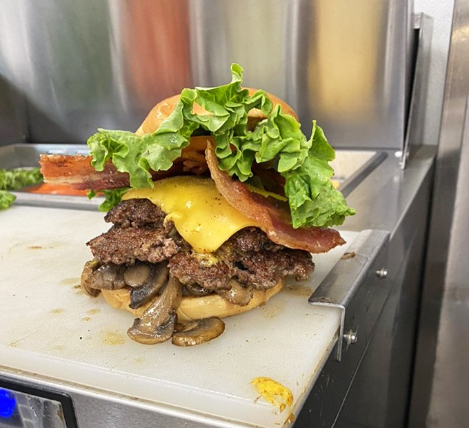 Architecture that defies gravity! This towering creation of beef, bacon, cheese, and mushrooms is the Burj Khalifa of burger engineering.