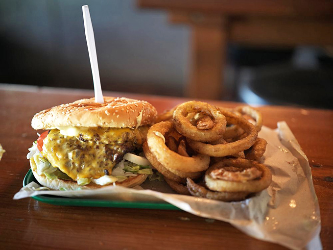 The golden rings of joy beside a double cheeseburger—a duo that's been making Oregonians smile longer than most marriages last.