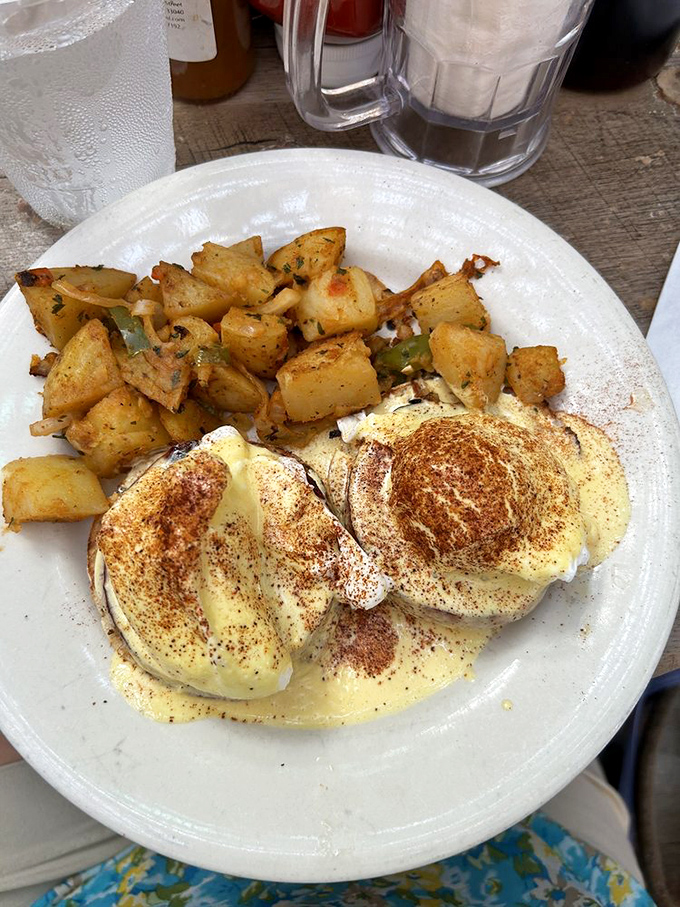 Eggs Benedict done right: perfectly poached eggs wearing hollandaise like a couture dress, with home fries that could make a potato farmer weep with pride.
