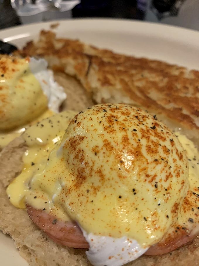 Eggs Benedict done right: perfectly poached eggs lounging on Canadian bacon like they're on vacation at a very delicious spa.