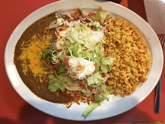 The Enchilada de la Casa arrives like a celebrity, dressed in sauce and cheese, with rice playing the perfect supporting role. No autographs necessary&mdash;just bring a fork.