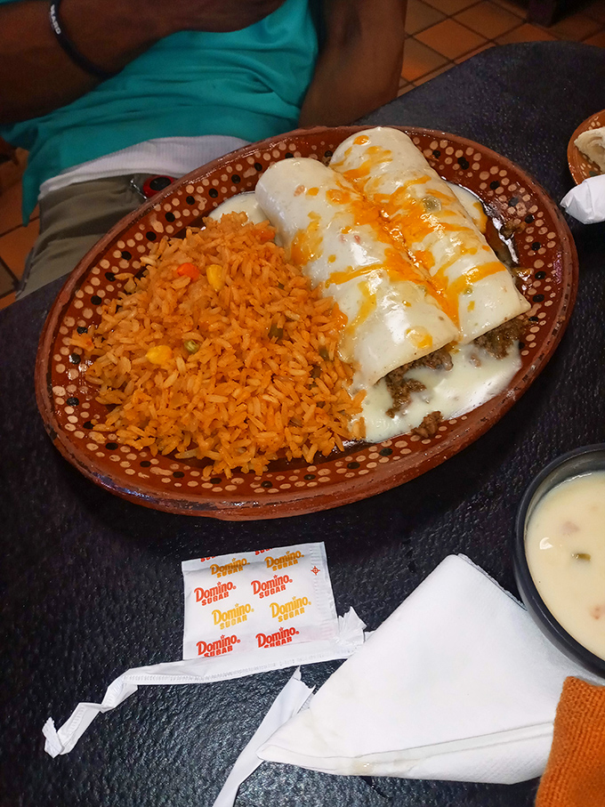 White cheese enchiladas sunbathing under yellow sauce—the Mexican equivalent of comfort food that hugs you from the inside out.