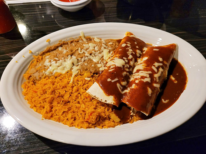 When enchiladas wear a mole sauce this rich, they deserve their own red carpet. The cheese sprinkle is just the paparazzi flash.