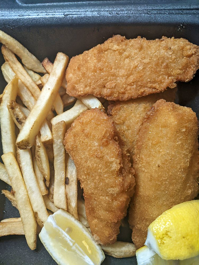 Golden-battered fish fillets with hand-cut fries&mdash;proof that sometimes the simplest pleasures are the most satisfying. That lemon wedge isn't just garnish&mdash;it's essential.