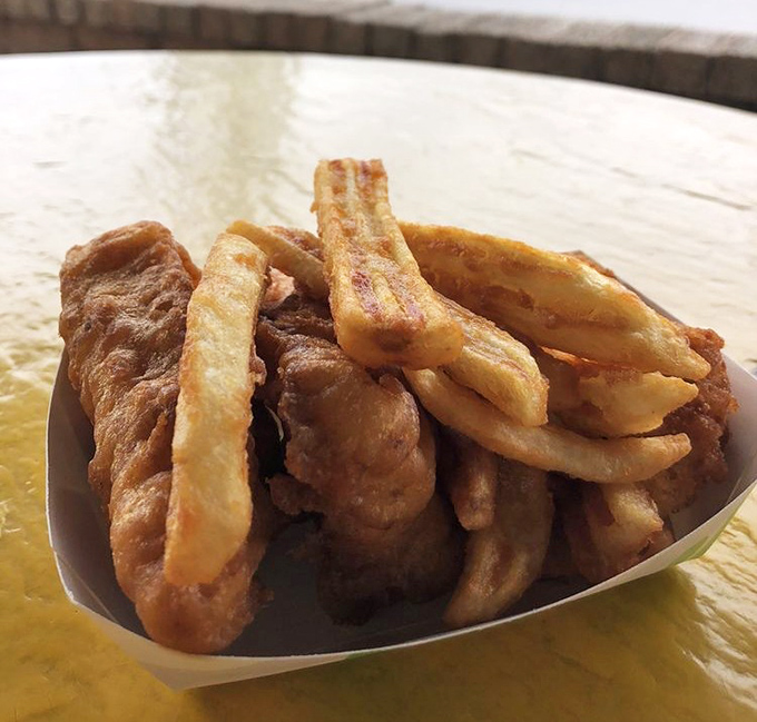 The paper boat might be humble, but what it carries is nothing short of deep-fried treasure&mdash;crispy on the outside, tender flakiness within.