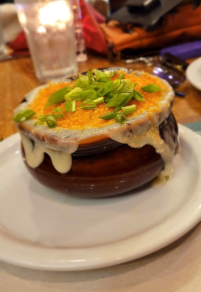 This isn't just French onion soup; it's a geological wonder with molten cheese cascading over a sturdy crock. Excavating through those layers is half the fun.