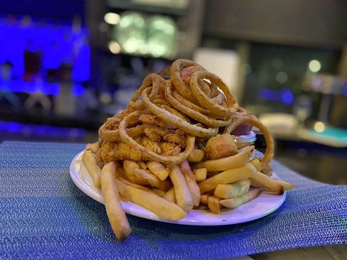 This isn't just a plate of food – it's an architectural marvel of fried seafood and french fries that demands both respect and elastic waistbands.