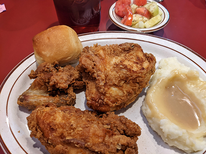 This isn't just fried chicken - it's edible poetry with a side of mashed potatoes and gravy.