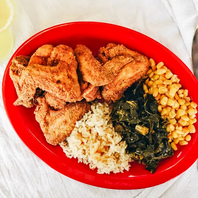 The kind of plate that makes conversation stop mid-sentence. Perfectly seasoned chicken, rice, greens, and beans&mdash;a balanced meal in the most delicious sense.