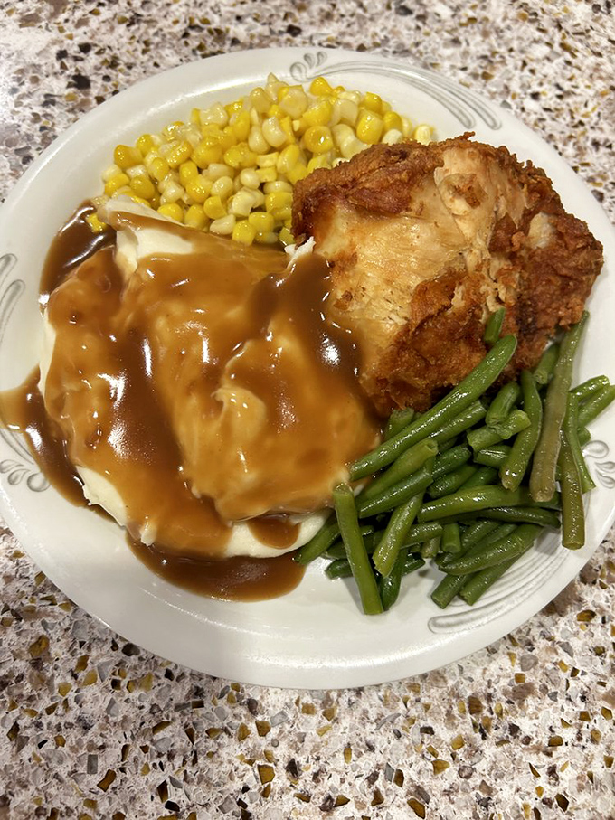 Comfort food nirvana: crispy fried chicken, buttery mashed potatoes, and vegetables that somehow make you feel virtuous while committing to glorious indulgence.