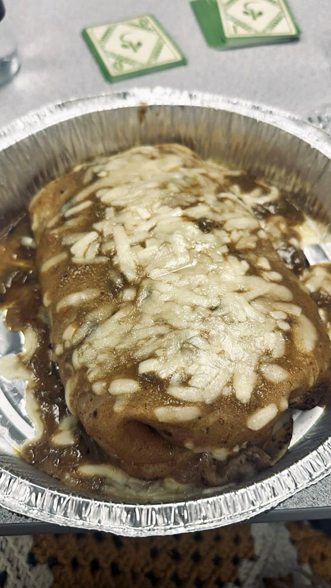 Swimming in sauce and blanketed with cheese, this enchilada-style burrito doesn't just satisfy hunger&mdash;it creates food memories that haunt you at midnight.