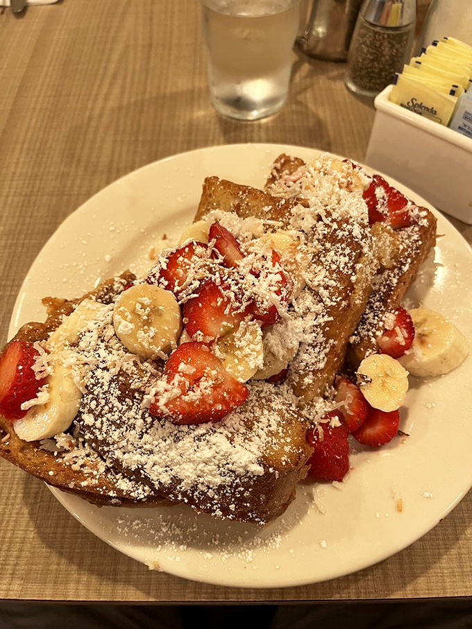 French toast that's dressed for success with strawberries, bananas, and a snowfall of powdered sugar. Breakfast or dessert? Yes, please.
