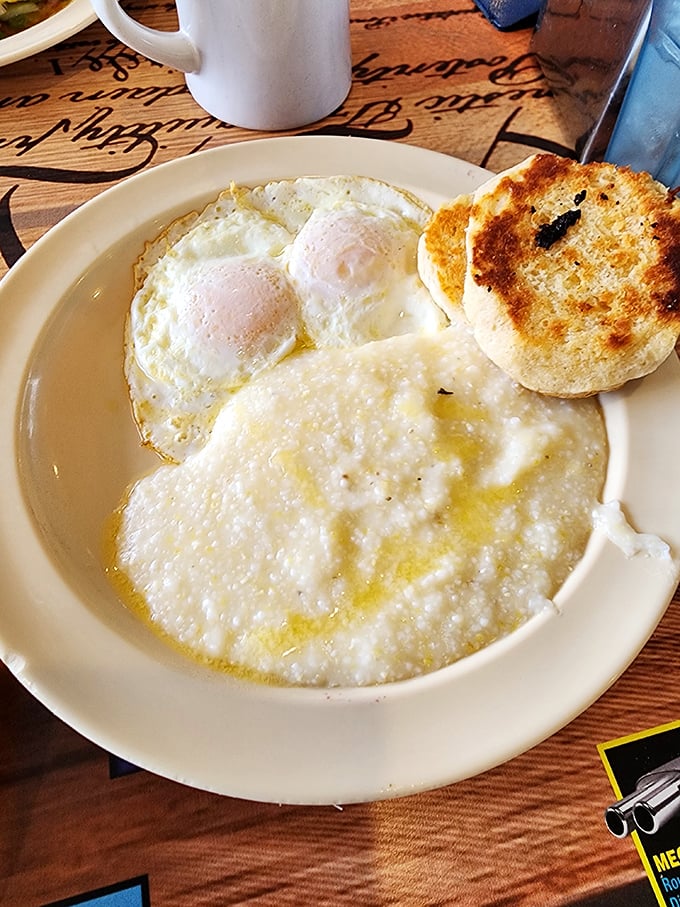 Sunny-side up eggs keeping watch over creamy grits and a golden biscuit &ndash; the holy trinity of Southern breakfast devotion.