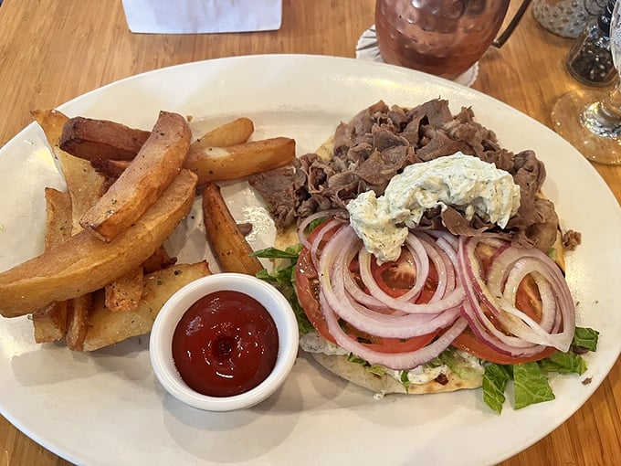 The gyro sandwich arrives with golden fries that deserve their own fan club. This isn't fast food &ndash; it's slow food served quickly.