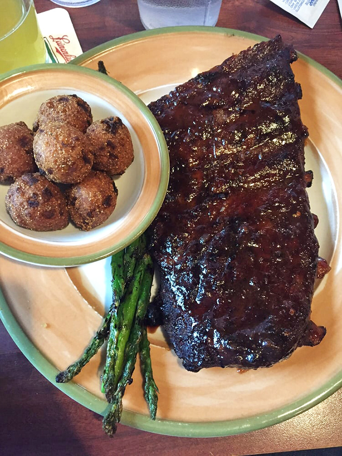 This half slab of ribs doesn't just share a plate with asparagus and hush puppies&mdash;it commands the plate with smoky authority.