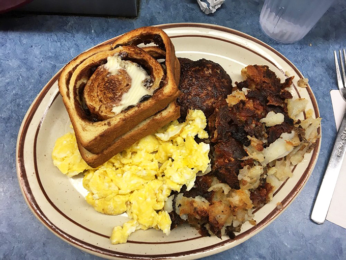 This is what morning victory looks like&mdash;scrambled eggs, a cinnamon roll with attitude, and hash browns that could make a potato weep with pride.