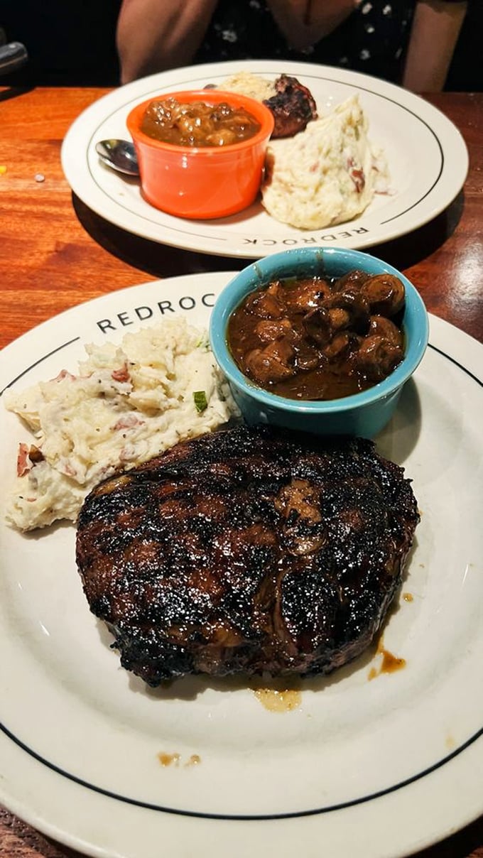 The ribeye arrives with such perfect grill marks, it looks like it's wearing a designer suit. That mushroom sauce? The accessory that completes the outfit.