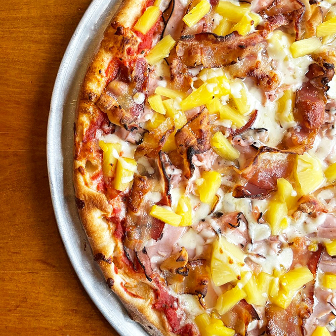 Hawaiian pizza done right: the sweet pineapple and savory ham create that controversial-yet-delicious combination that divides families but conquers taste buds.