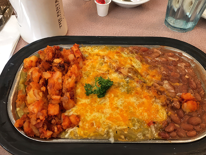 Huevos rancheros: where eggs meet their destiny atop a tortilla throne, crowned with melted cheese and surrounded by loyal subjects of beans and potatoes.
