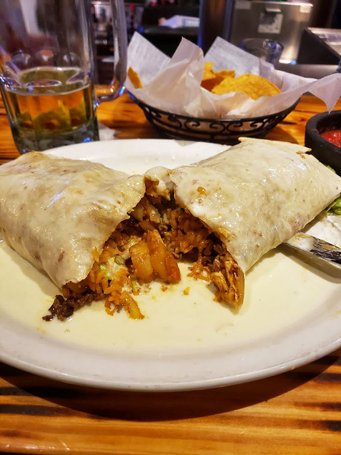 One bite reveals the burrito's inner secrets: perfectly seasoned meat, rice, and beans mingling together in what can only be described as a tortilla-wrapped miracle.