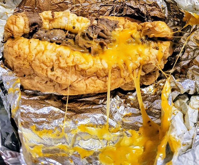 When cheese meets perfectly seasoned beef in a dipped Italian roll, it's less a sandwich and more a religious experience.