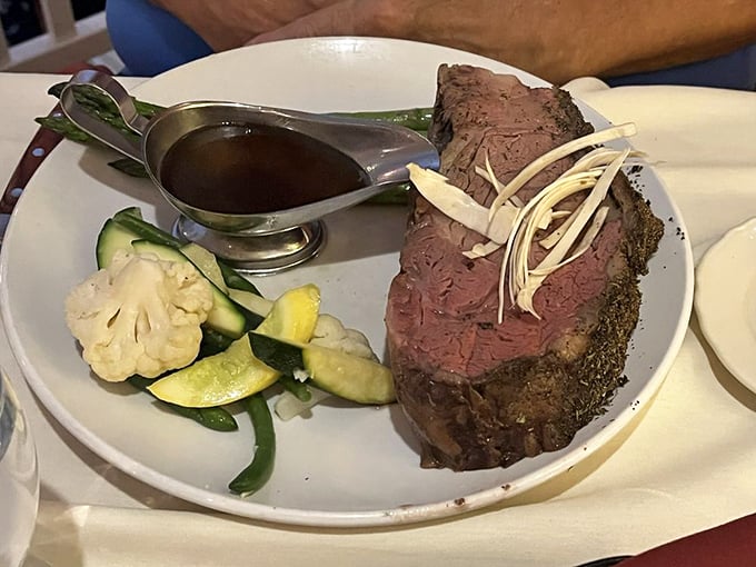 The King Cut Prime Rib arrives like royalty, sporting a herb-crusted exterior and that perfect shade of pink that makes carnivores go weak at the knees.