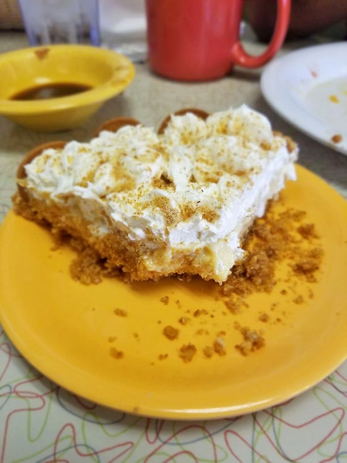 The legendary lemon icebox pie sits regally on its sunshine-yellow plate, a perfect balance of tart and sweet that's worth every calorie.