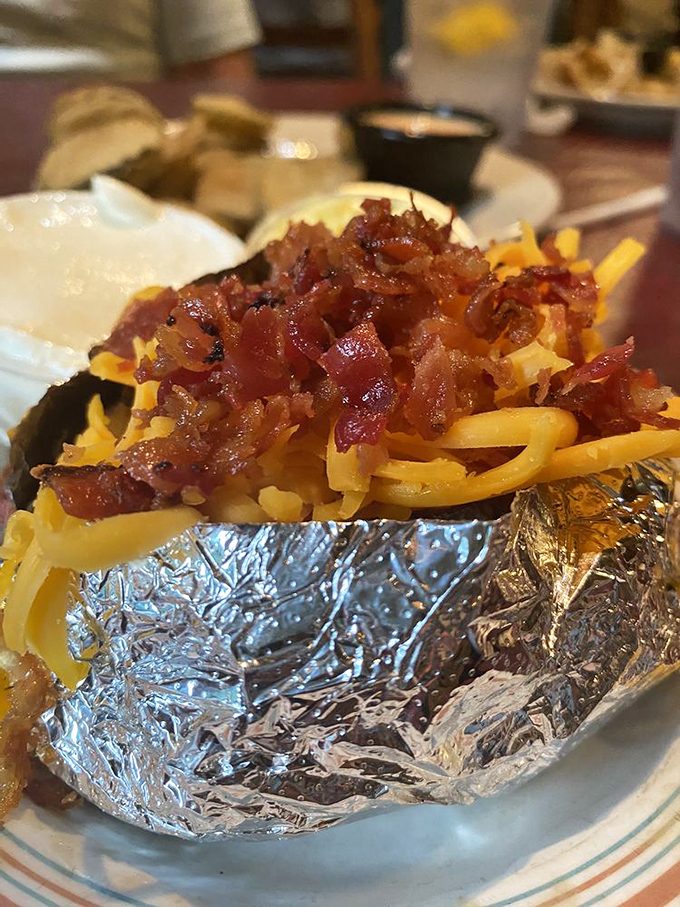 A loaded baked potato that's dressed better than most people at formal events&mdash;cheese, bacon, and all the fixings.
