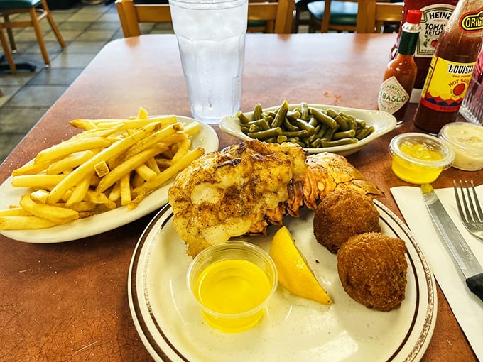 A feast fit for Neptune himself&mdash;golden fries, vibrant green beans, and a lobster tail that practically begs for that cup of melted butter.