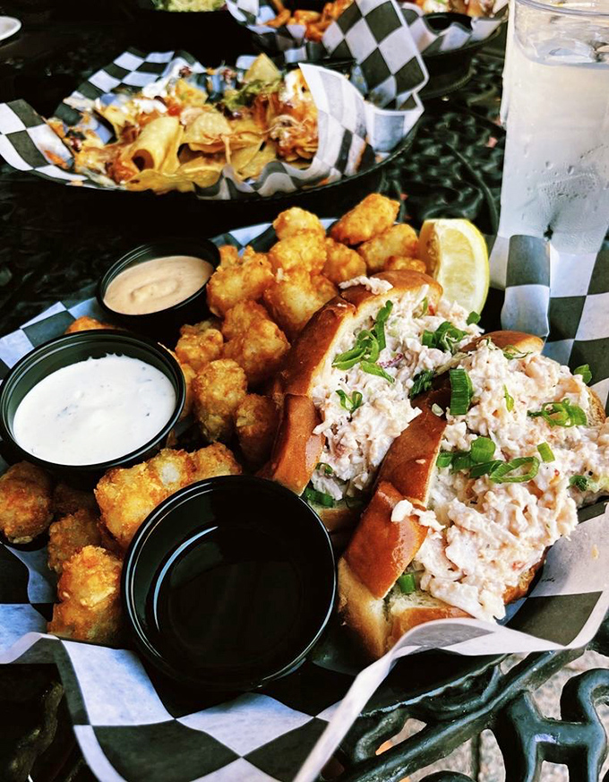 Lobster and tater tots: a pairing so perfect it makes you wonder why fancy restaurants bother with white tablecloths when checkered paper does the job beautifully.