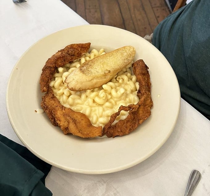 Comfort food nirvana: crispy hand-breaded chicken creates the perfect golden frame for creamy three-cheese mac &ndash; the culinary equivalent of a warm blanket.