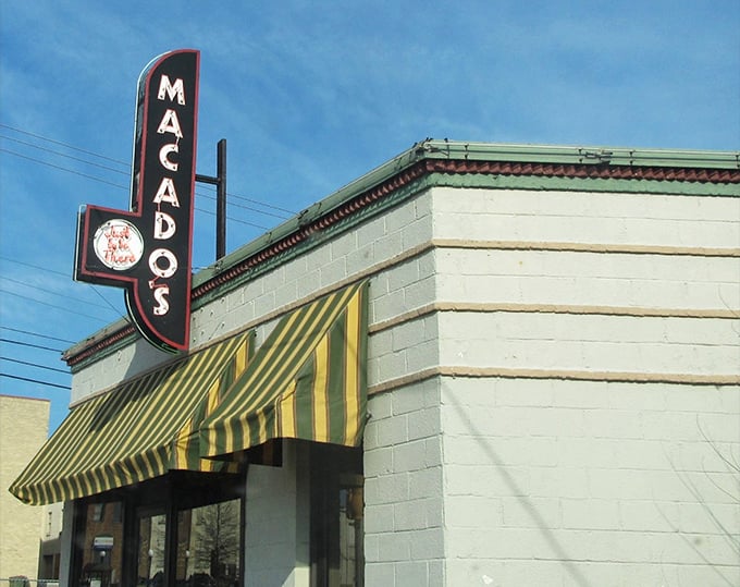 Macado's iconic sign stands as a beacon for hungry travelers, promising sandwiches substantial enough to require a nap afterward.