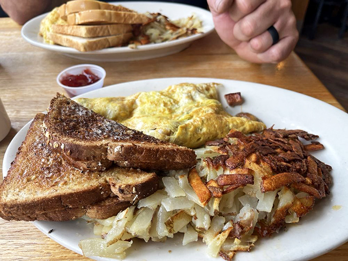This isn't just breakfast&mdash;it's architecture. Golden toast, crispy hash browns, and an omelet that's practically bursting with breakfast potential. 
