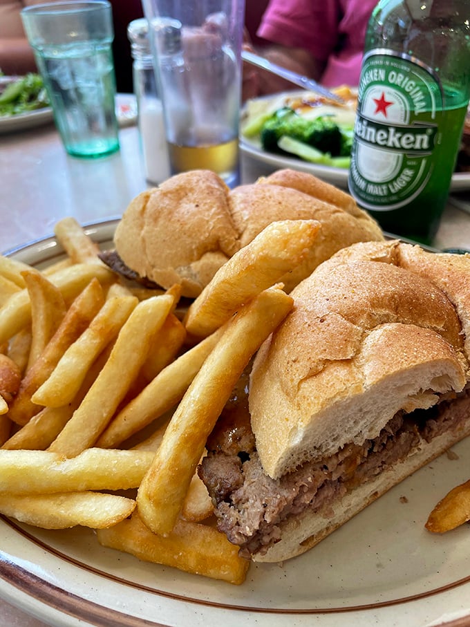This sandwich isn't just lunch&mdash;it's an architectural masterpiece of bread, meat, and crispy fries that demands both hunger and strategy.