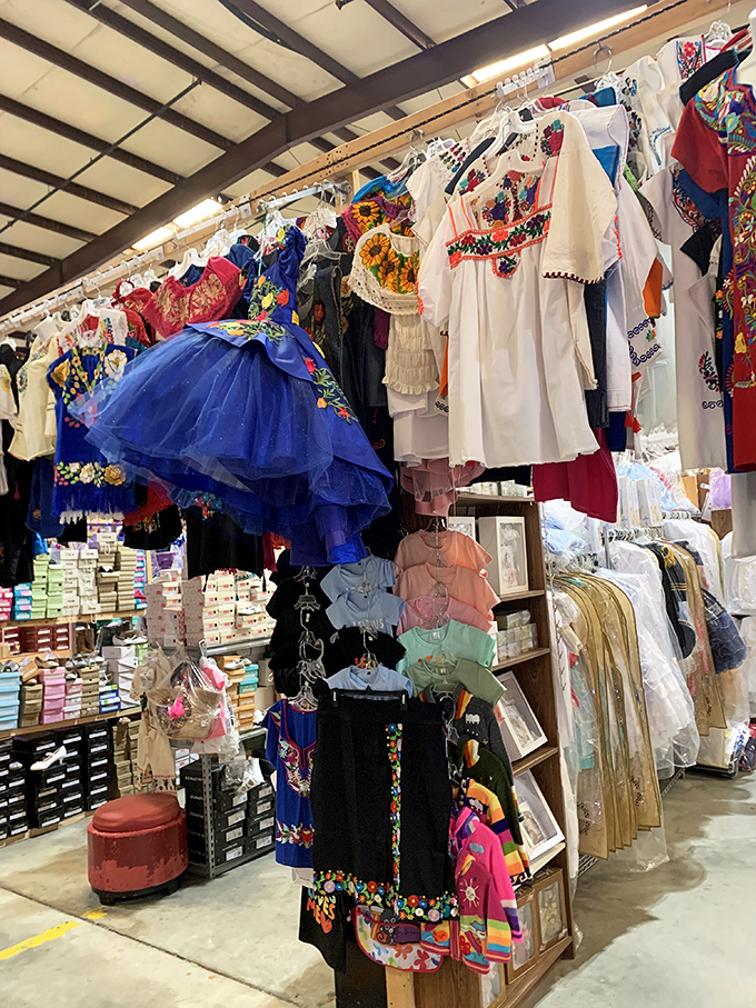 Traditional Mexican dresses add vibrant cultural splash to the marketplace, hanging like colorful promises of fiestas yet to come.