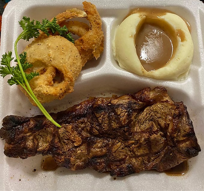 The takeout steak doesn't compromise on quality&mdash;a perfectly crusted exterior with juicy interior, paired with onion rings and a gravy-filled mashed potato crater.