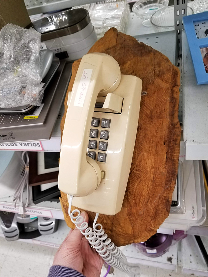 "Hello, 1985 called..." This wall-mounted push-button relic would make Gordon Gekko proud, mounted on what appears to be a wooden slice.