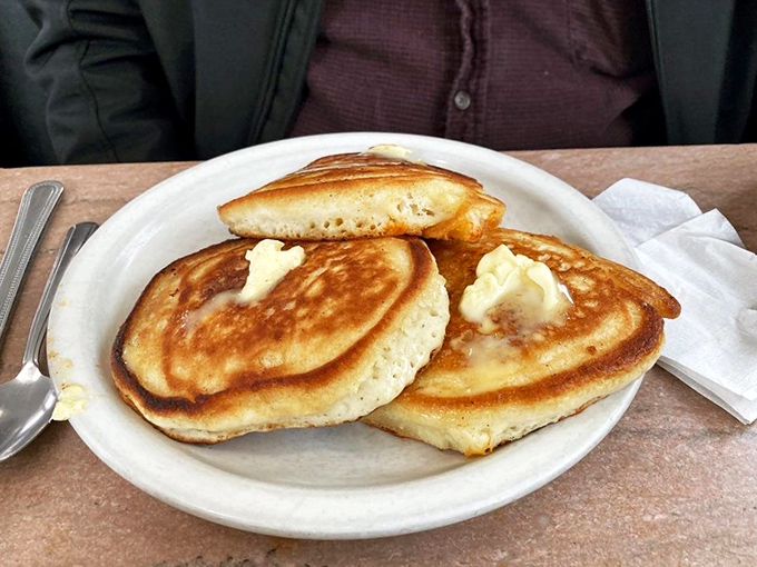 These golden pancakes aren't just breakfast&mdash;they're edible sunshine, complete with melting butter pools creating their own little flavor lakes.