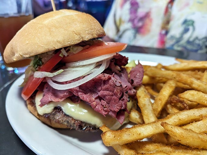 This isn't just a burger&mdash;it's a skyscraper of flavor with pastrami reaching for the heavens and fries standing guard like delicious sentinels.