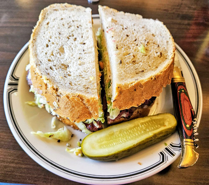 Architecture matters: layers of hand-cut pastrami, Swiss cheese, and coleslaw create the perfect structural integrity for maximum flavor delivery.